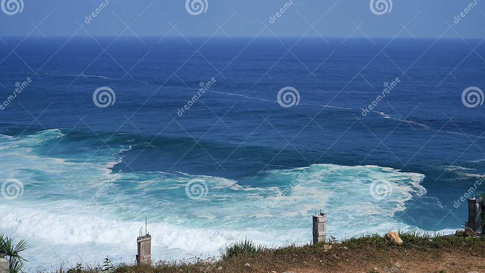 View of the Beach from the Top of the Cliff, Small Waves and White Foam ...