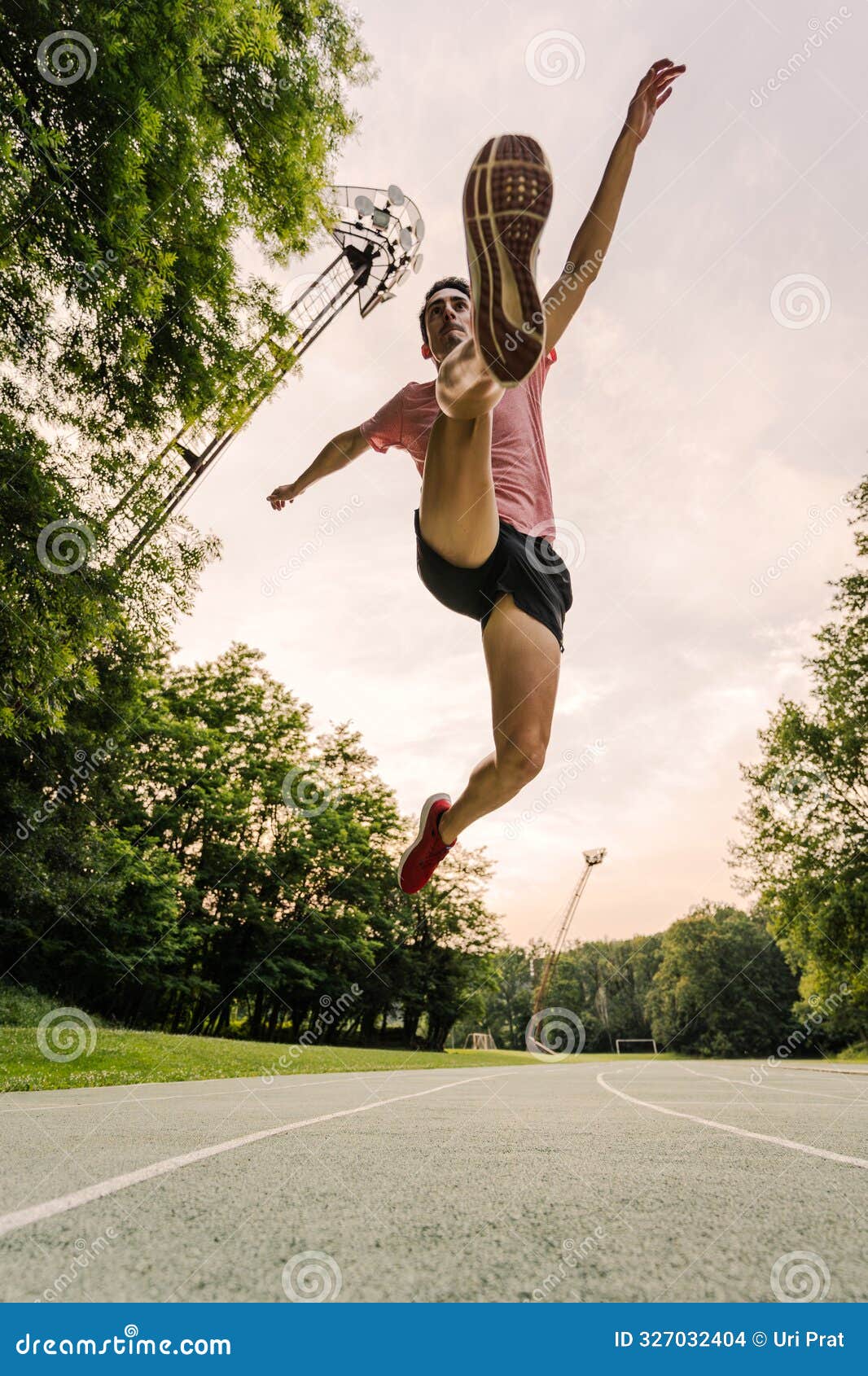 View from Below of an Athlete Running Fast in a Race on the Athletics ...