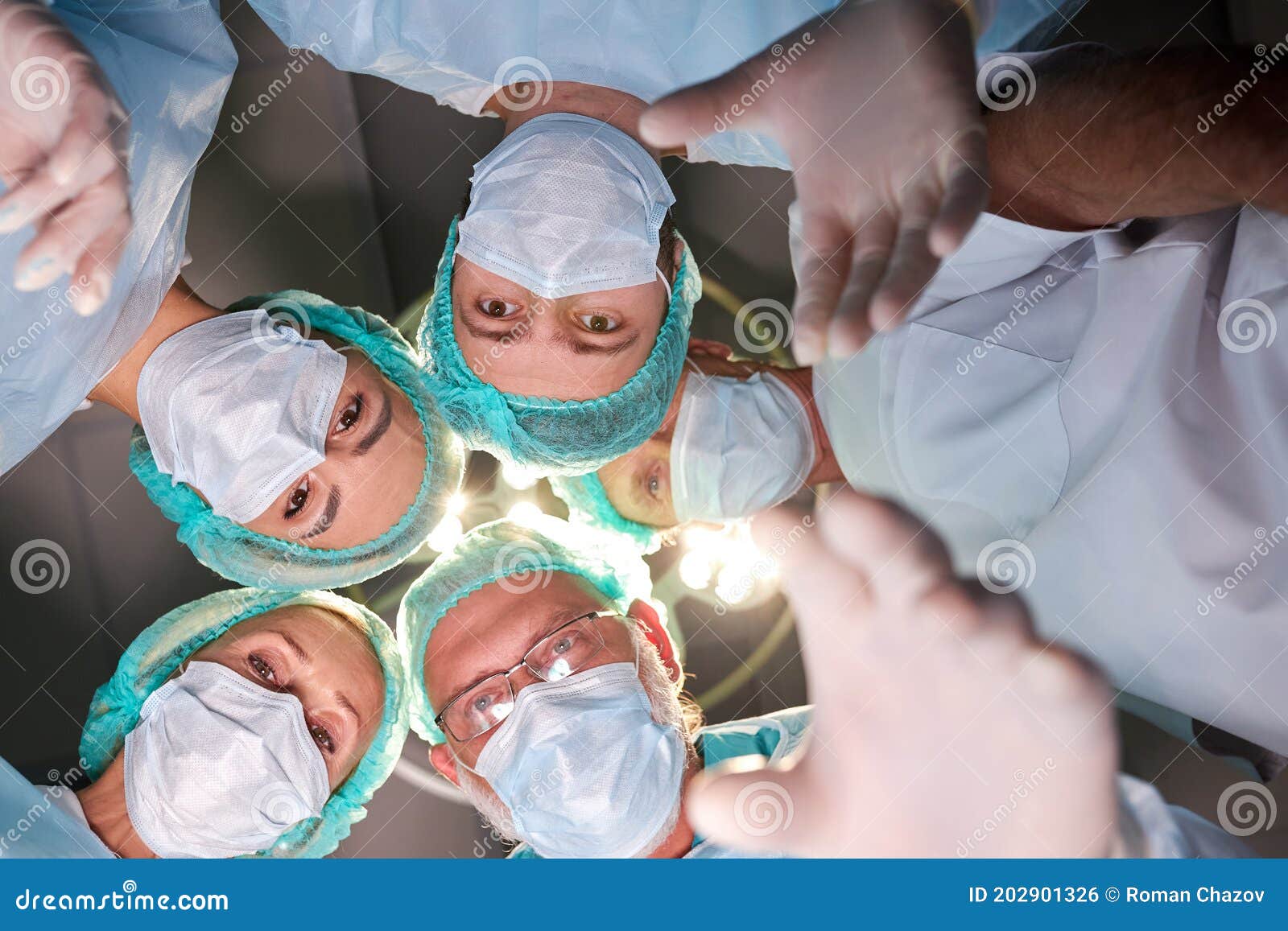 View from Below of Doctors Looking at Patient after Operation on ...