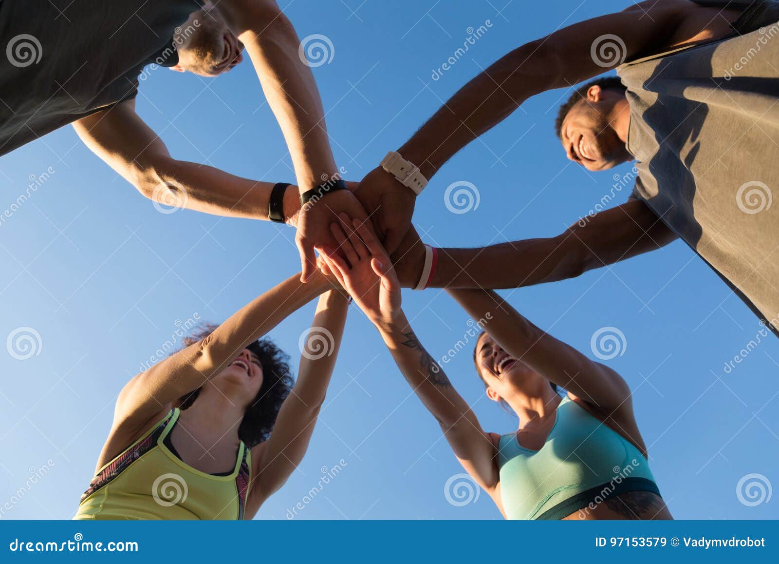 View from Below of a Group of Sporty People in a Huddle Stock Image ...