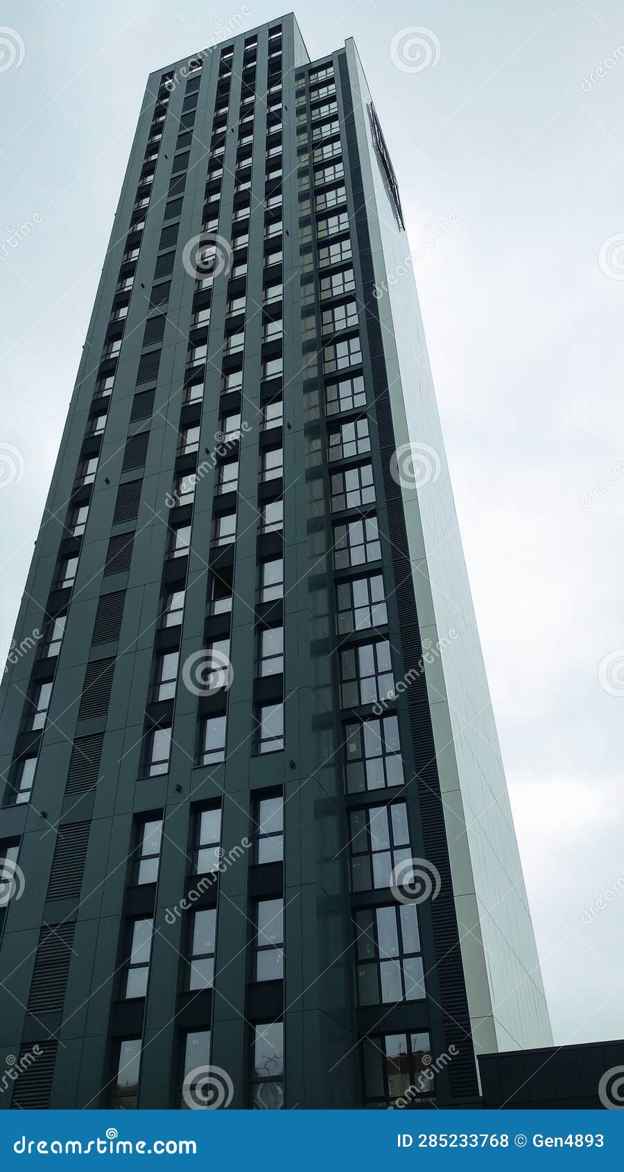 A View from Below of a Tall Multi-storey Building Against a Gloomy Sky ...