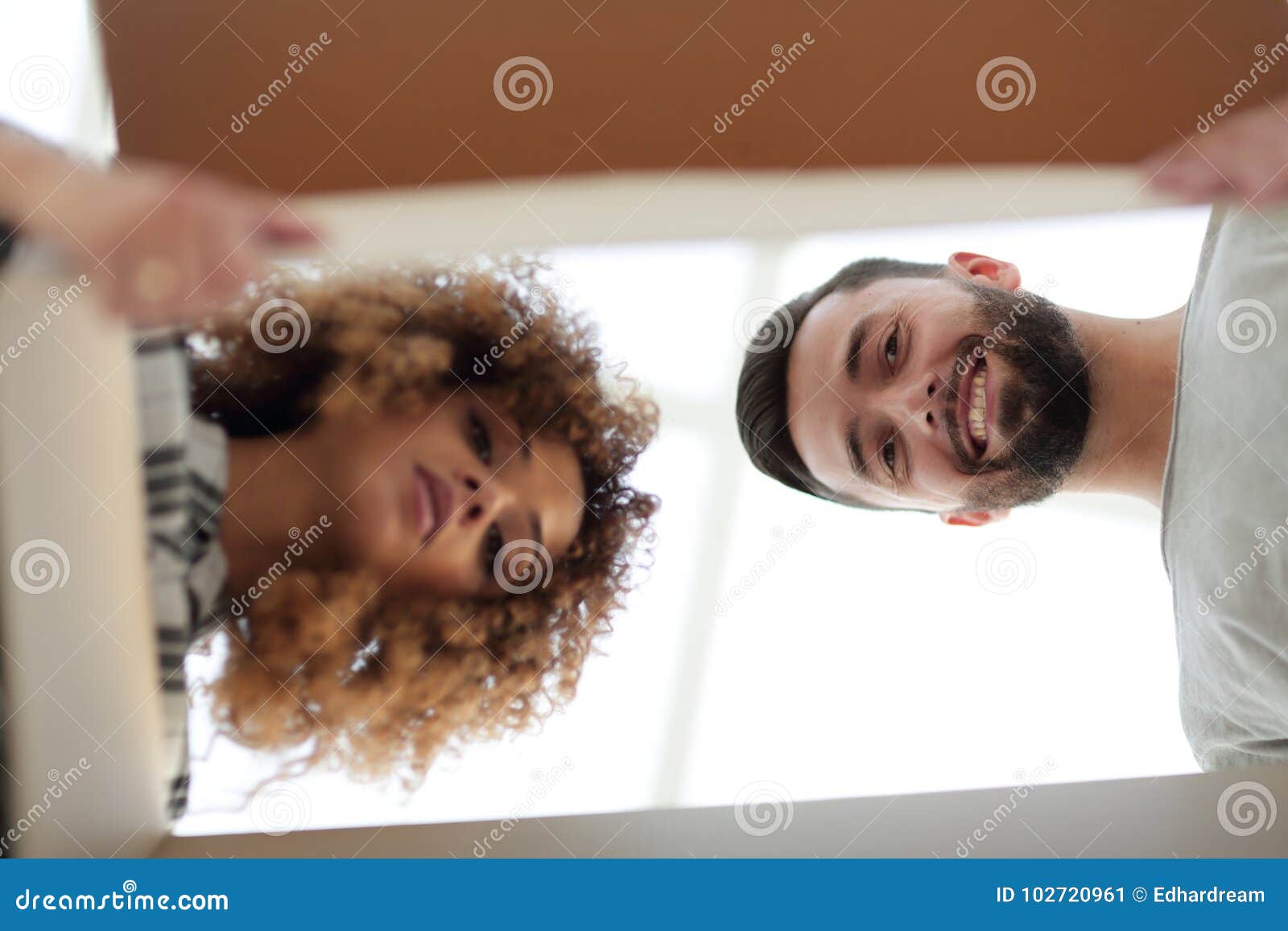 View from Below a Young Couple Looking Inside the Box. Stock Image ...