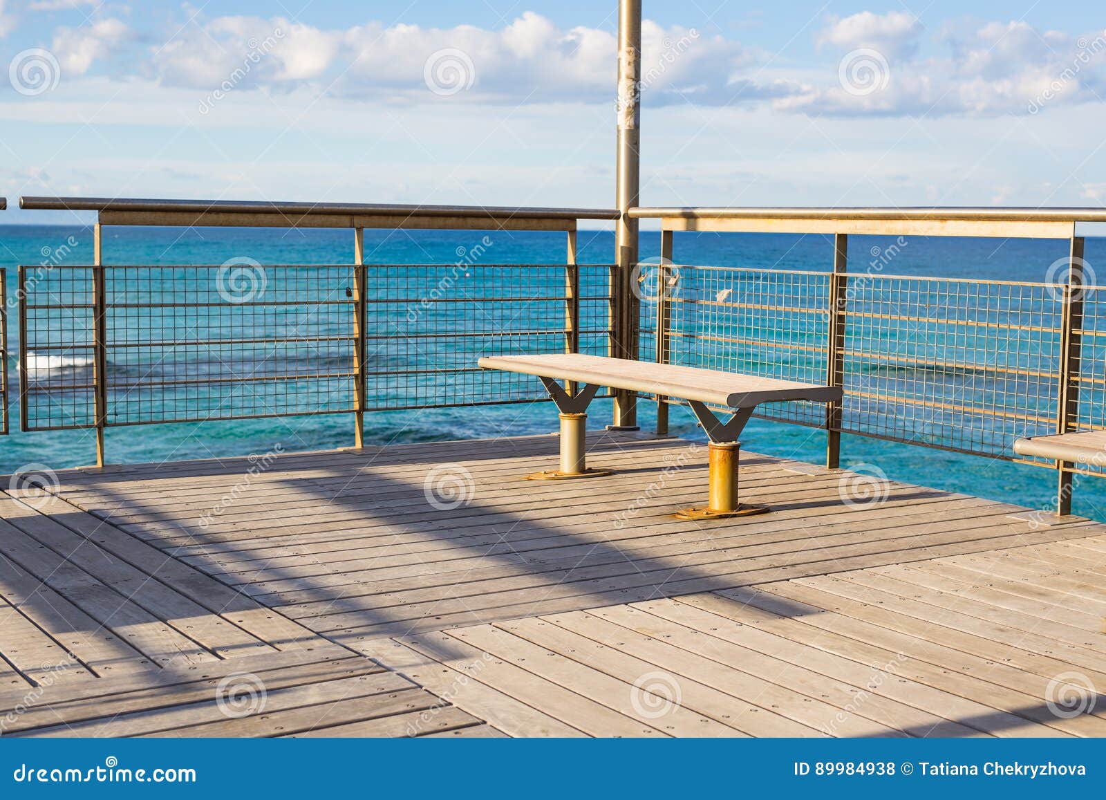 View of a bench on pier stock photo. Image of ocean, cloud - 89984938