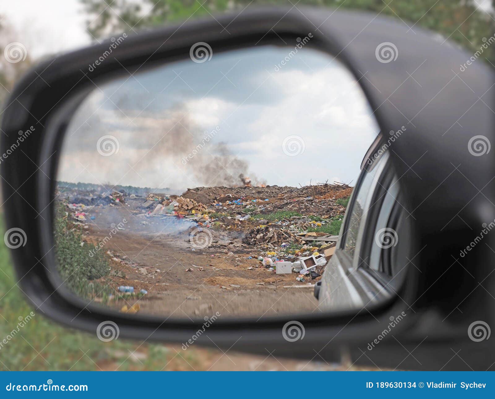 View of a Burning Garbage Dump through a Car Mirror Stock Photo - Image ...