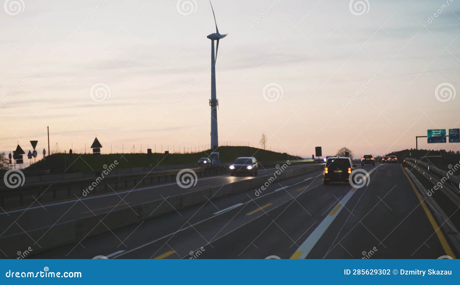 View from the Car while Driving on a Wind Generator Standing Near the ...
