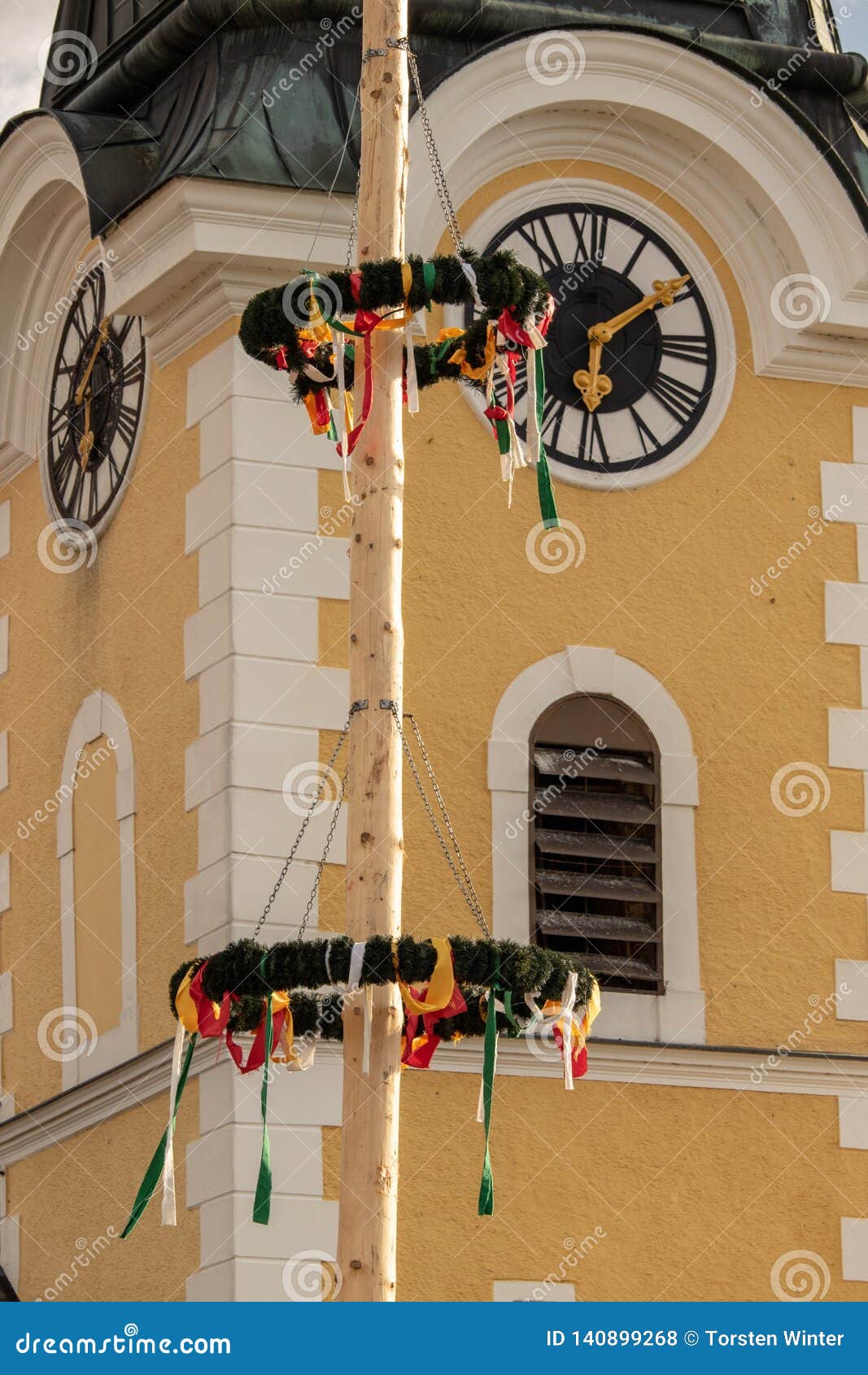 View of a Church Tower in the Background with a Maypole in the ...