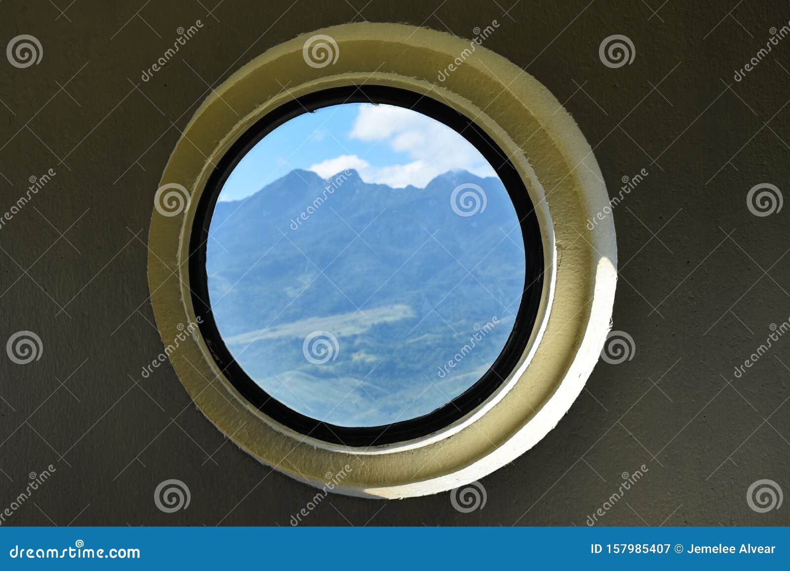 A View from a Circular Window of a Building Overlooking a Mountain ...