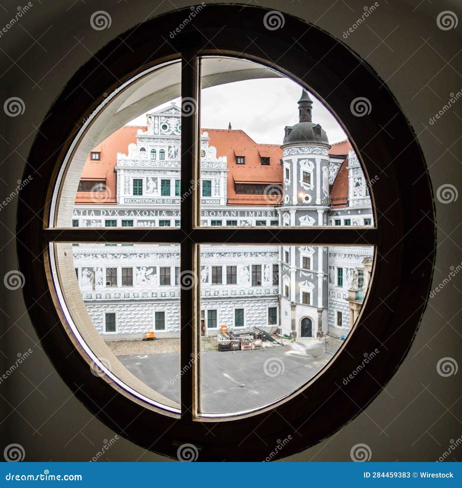 The View from Inside a Round Window at a Building with a Clock Tower ...