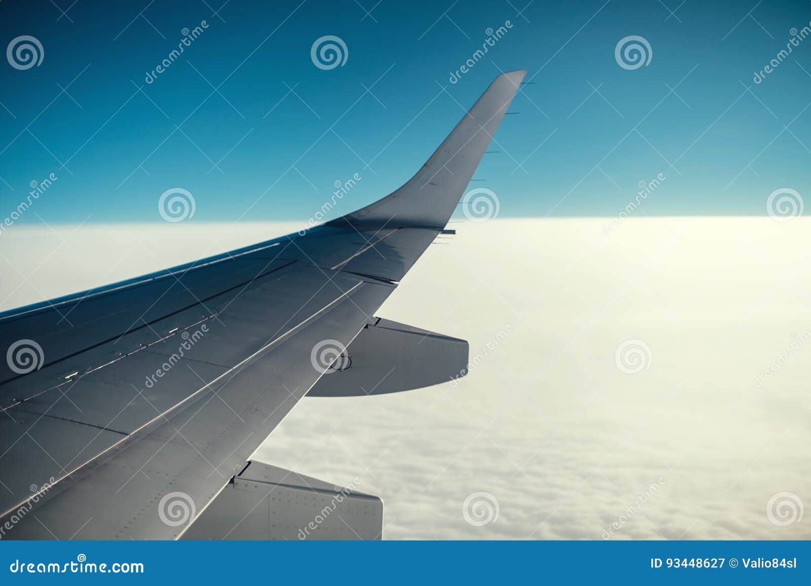 View of the Clouds and Airplane Wing from the Inside Stock Image ...