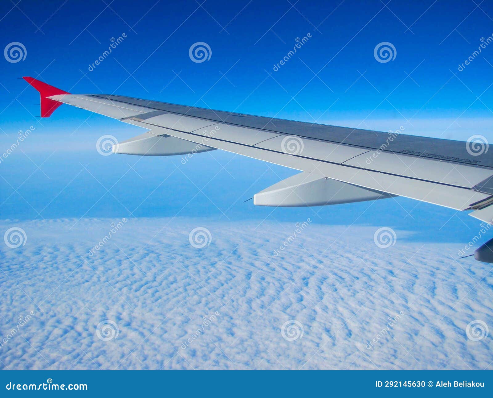View of the Clouds Under the Wing of an Airplane from Below Stock Photo ...