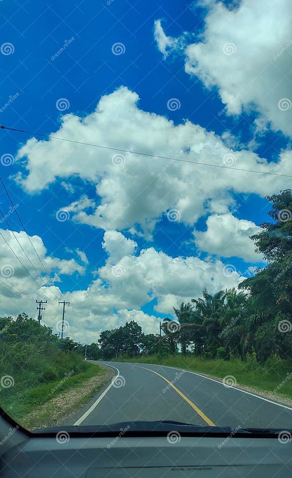 View of the Cloudy Sky from Inside a Car Driving on the Road Stock ...