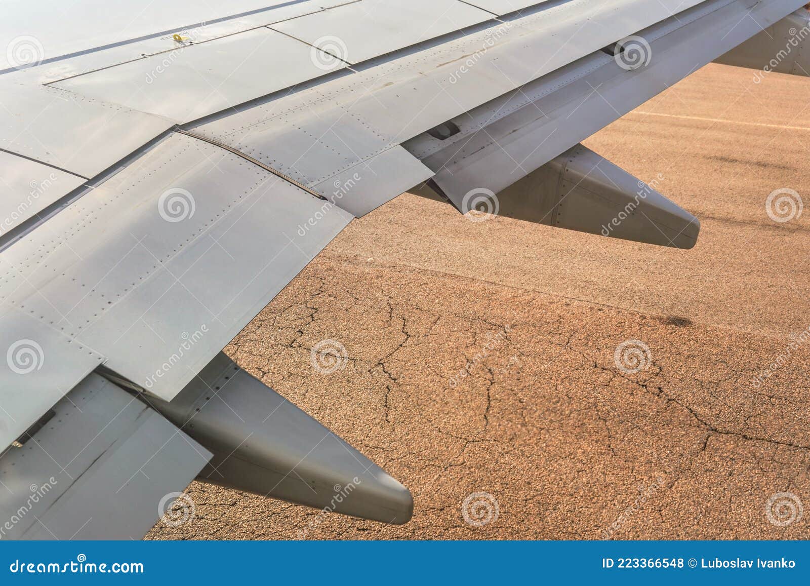 Brown Asphalt Shingled Roof With Gutter And Spout On Weathered Siding ...
