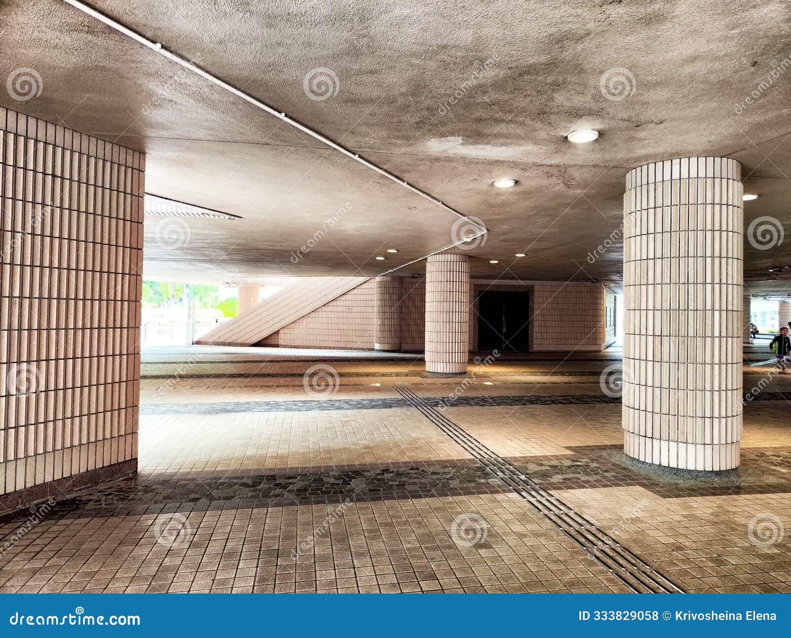 A View of a Concrete Underpass with Tile Columns and a Tiled Floor ...