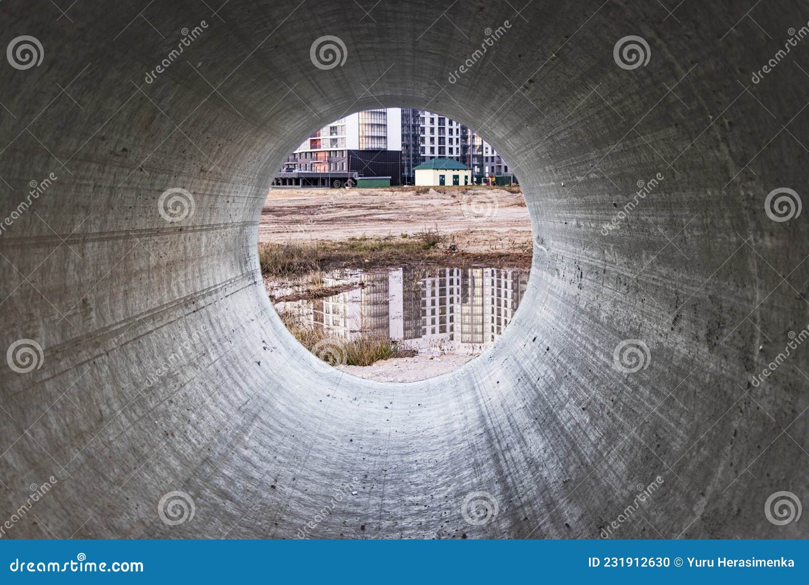 View of the Construction Site through a Concrete Pipe. Mounting of ...