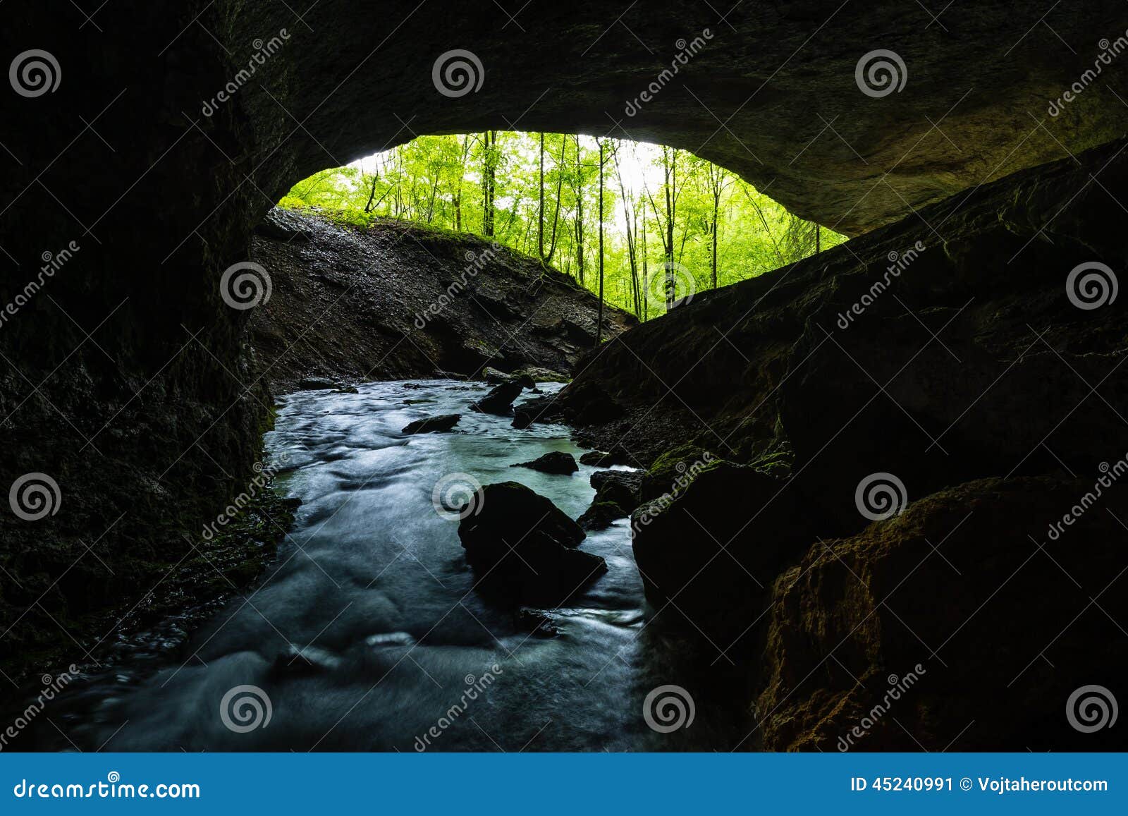 View from Dark Cave into Green Forest Stock Image - Image of dramatic ...