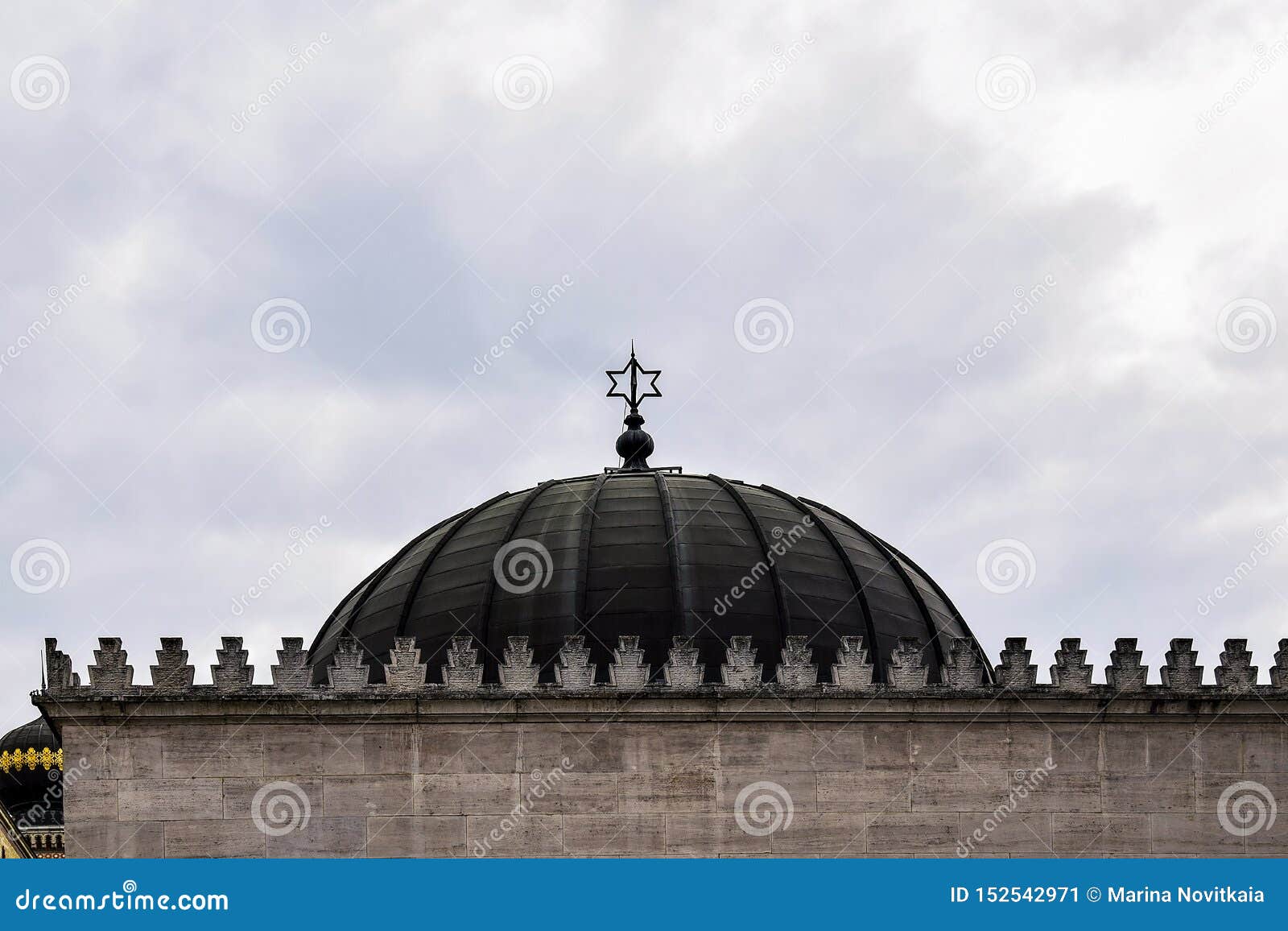 View of the Dome of the Synagogue with a Star of David on a Cloudy Sky ...