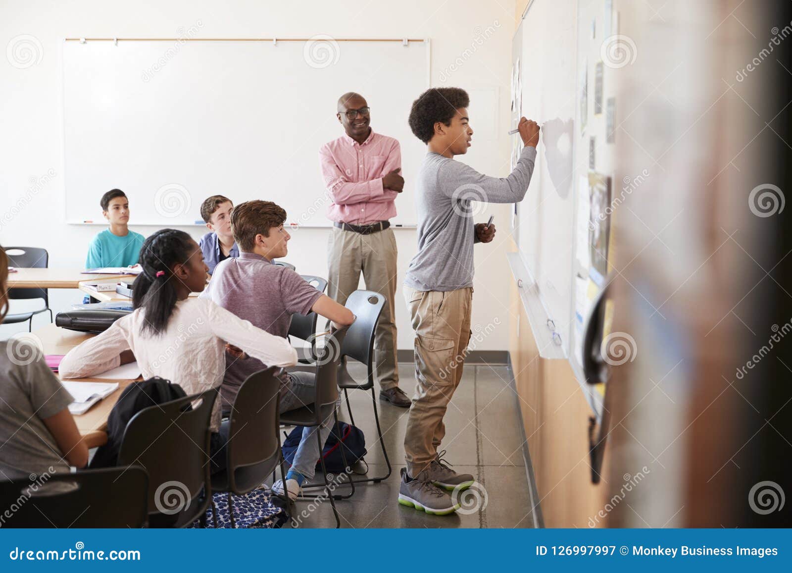 View through Doorway of High School Pupil Writing on Whiteboard in ...