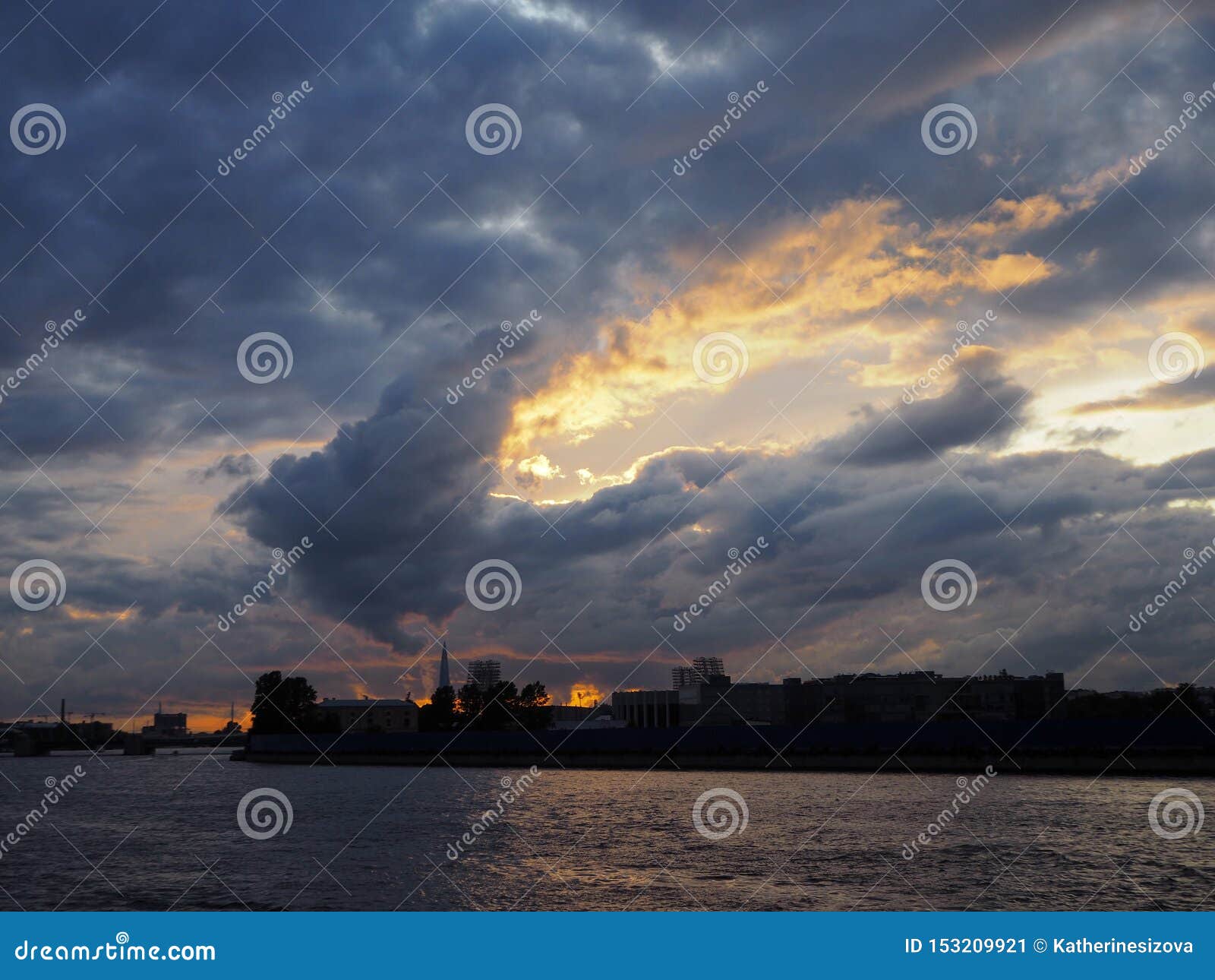 View of the Dramatic Sky Above the Sity at Sunset with Dark Blue Clouds ...
