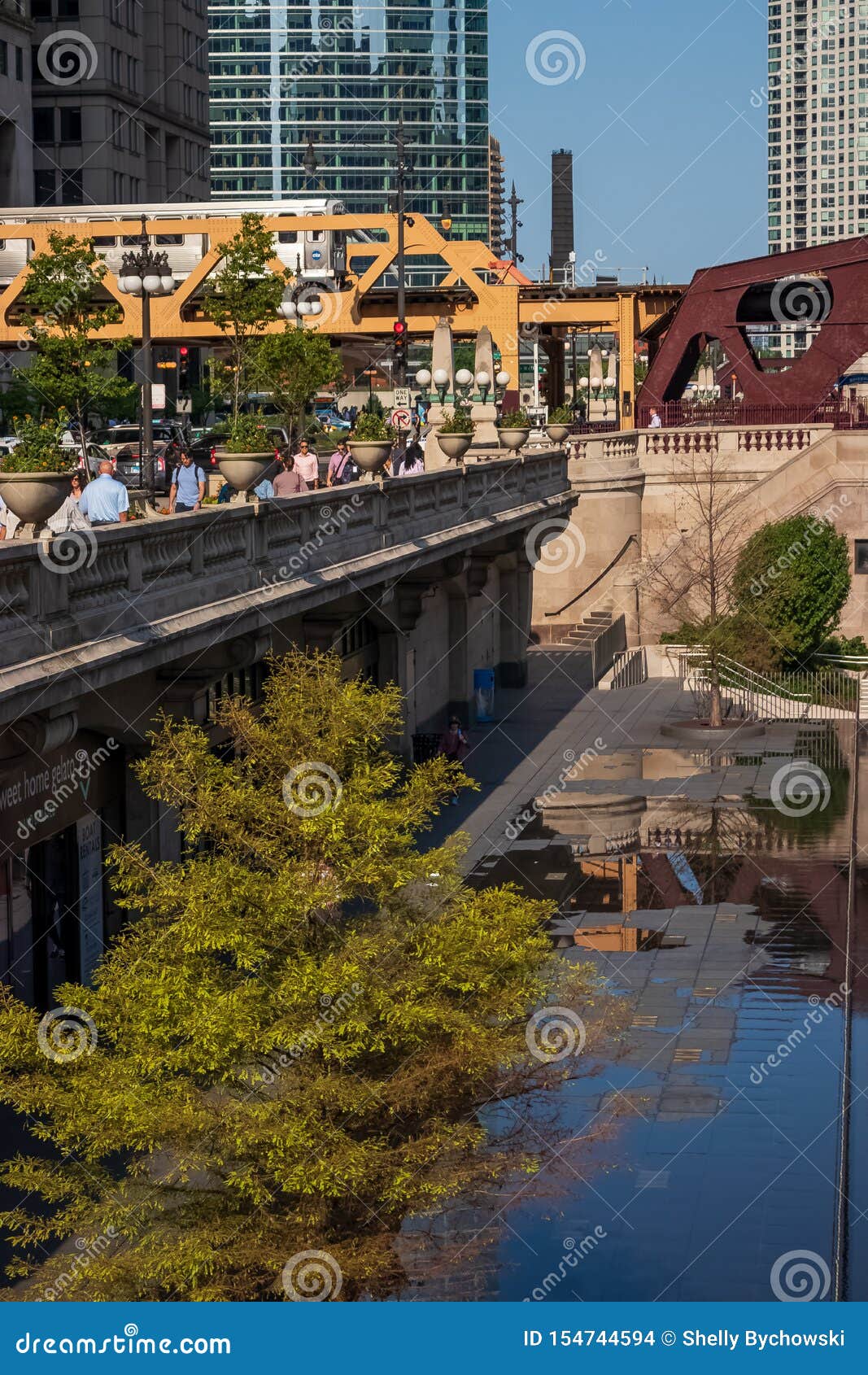 View of El Train Crossing Wacker Dr & Riverwalk while Commuters Rush ...