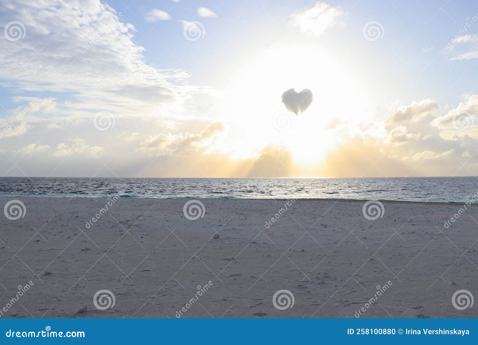 View of an Empty Beach and Ocean, a Heart-shaped Cloud in the Sky ...