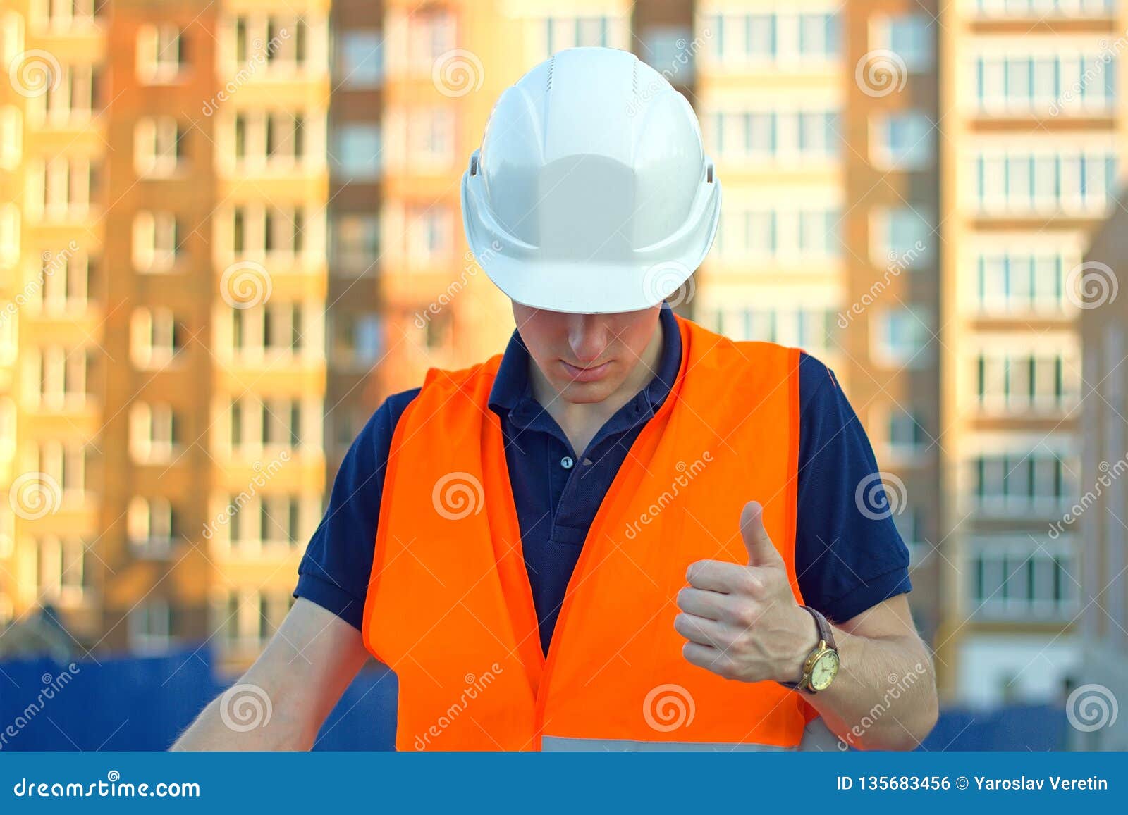 View of an Engineer and Worker Watching Blueprint on Construction Site ...