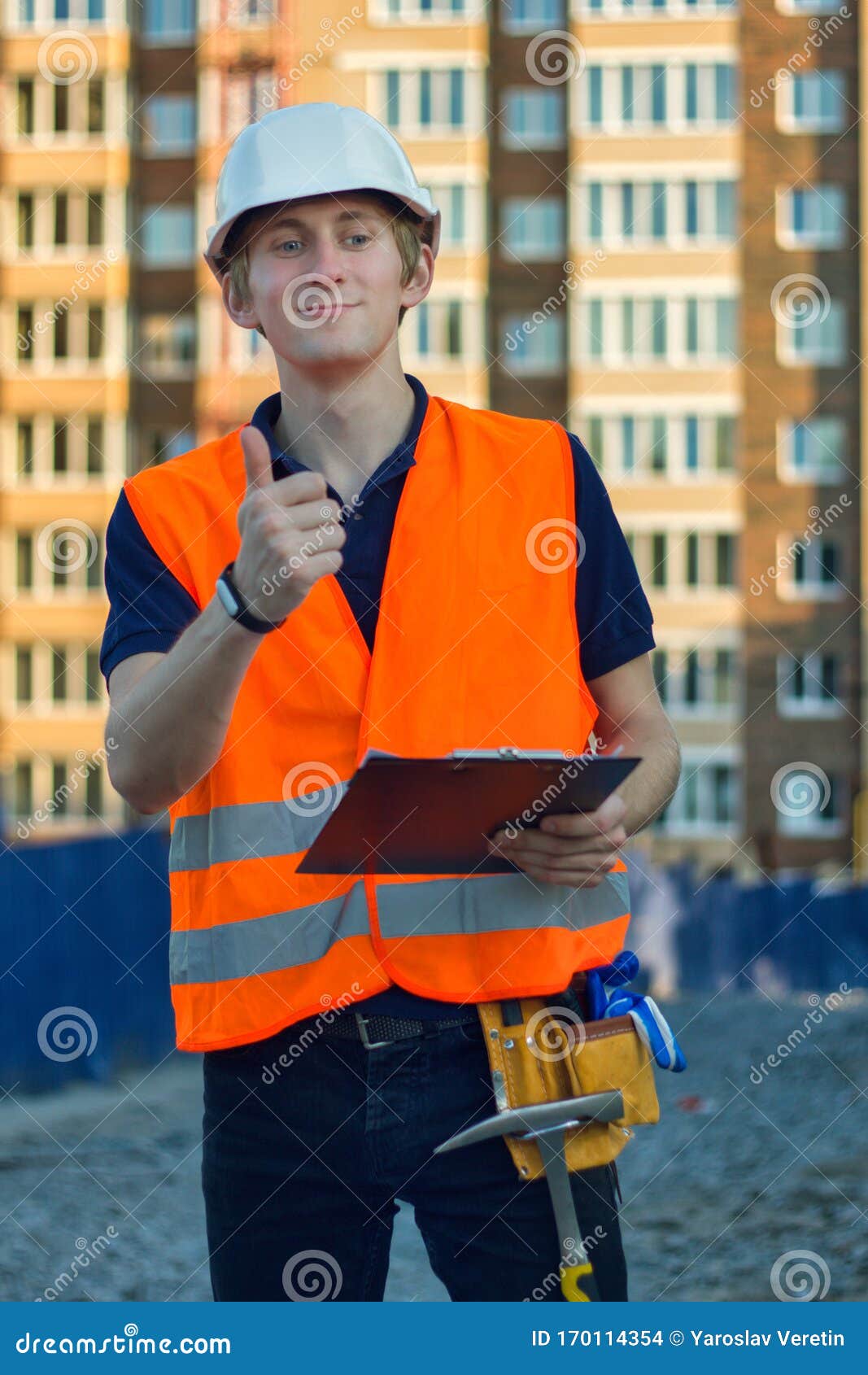 View of an Engineer and Worker Watching Blueprint on Construction Site ...