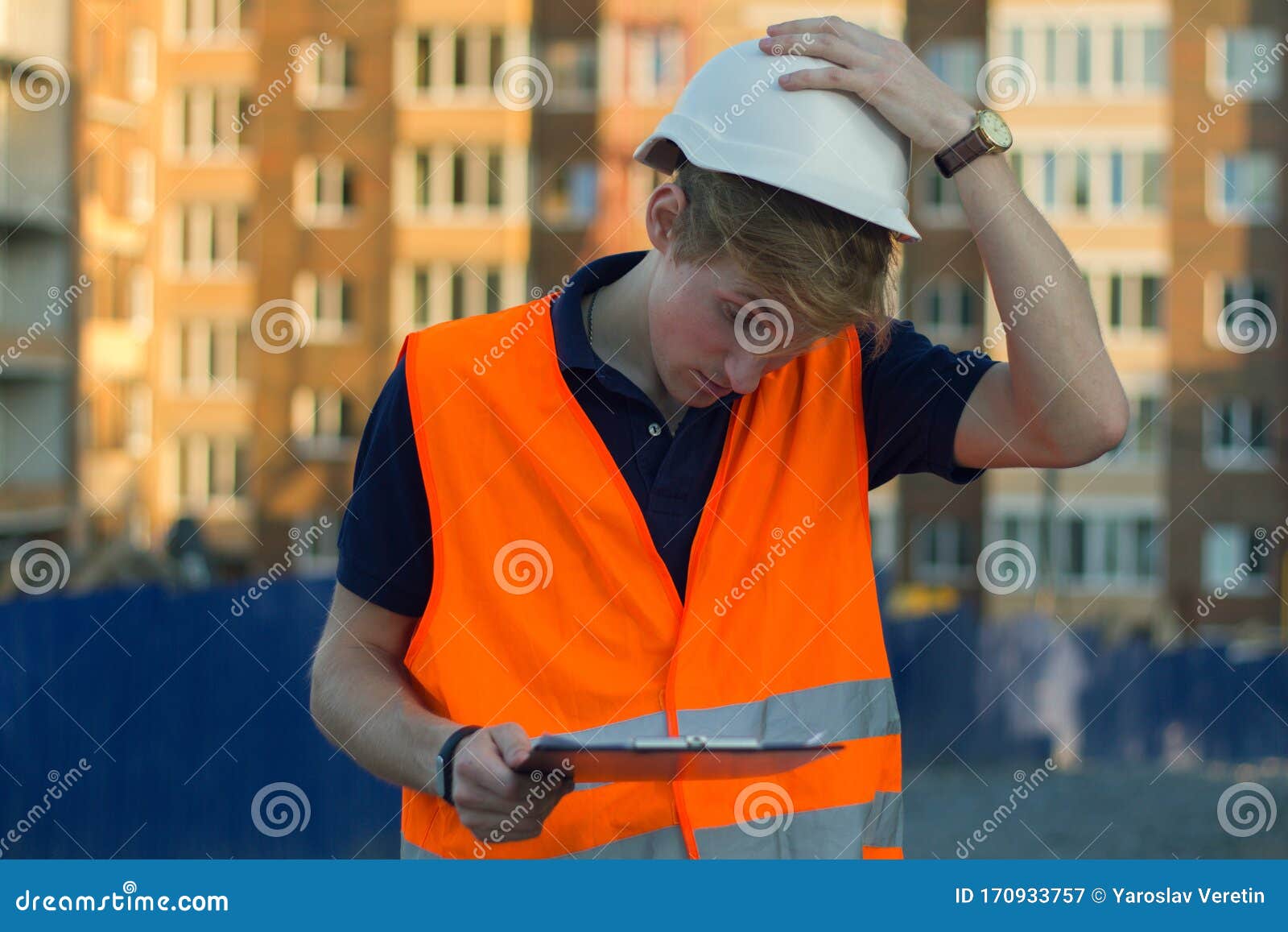 View of an Engineer and Worker Watching Blueprint on Construction Site ...