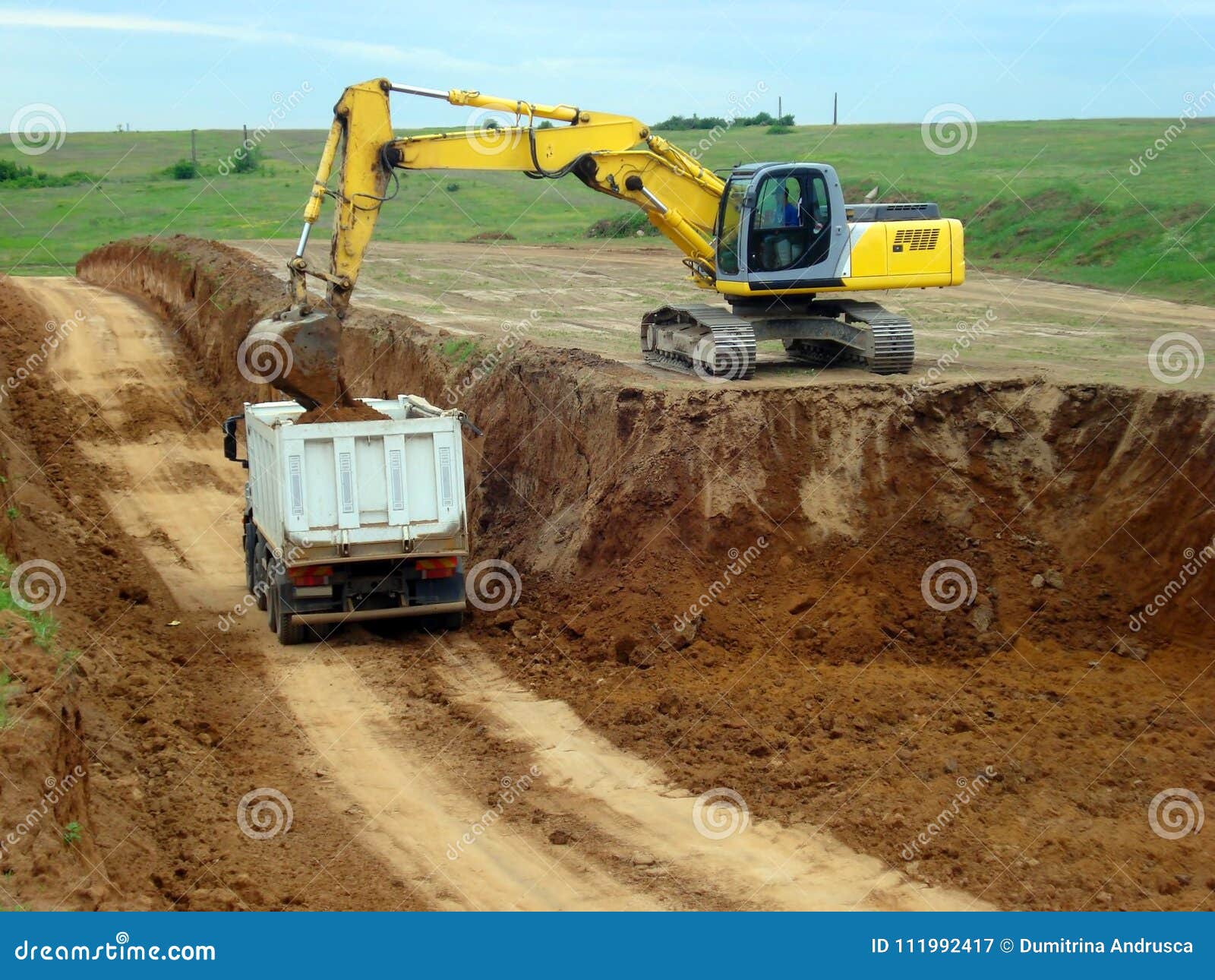 Excavator load the truck stock image. Image of construct - 111992417