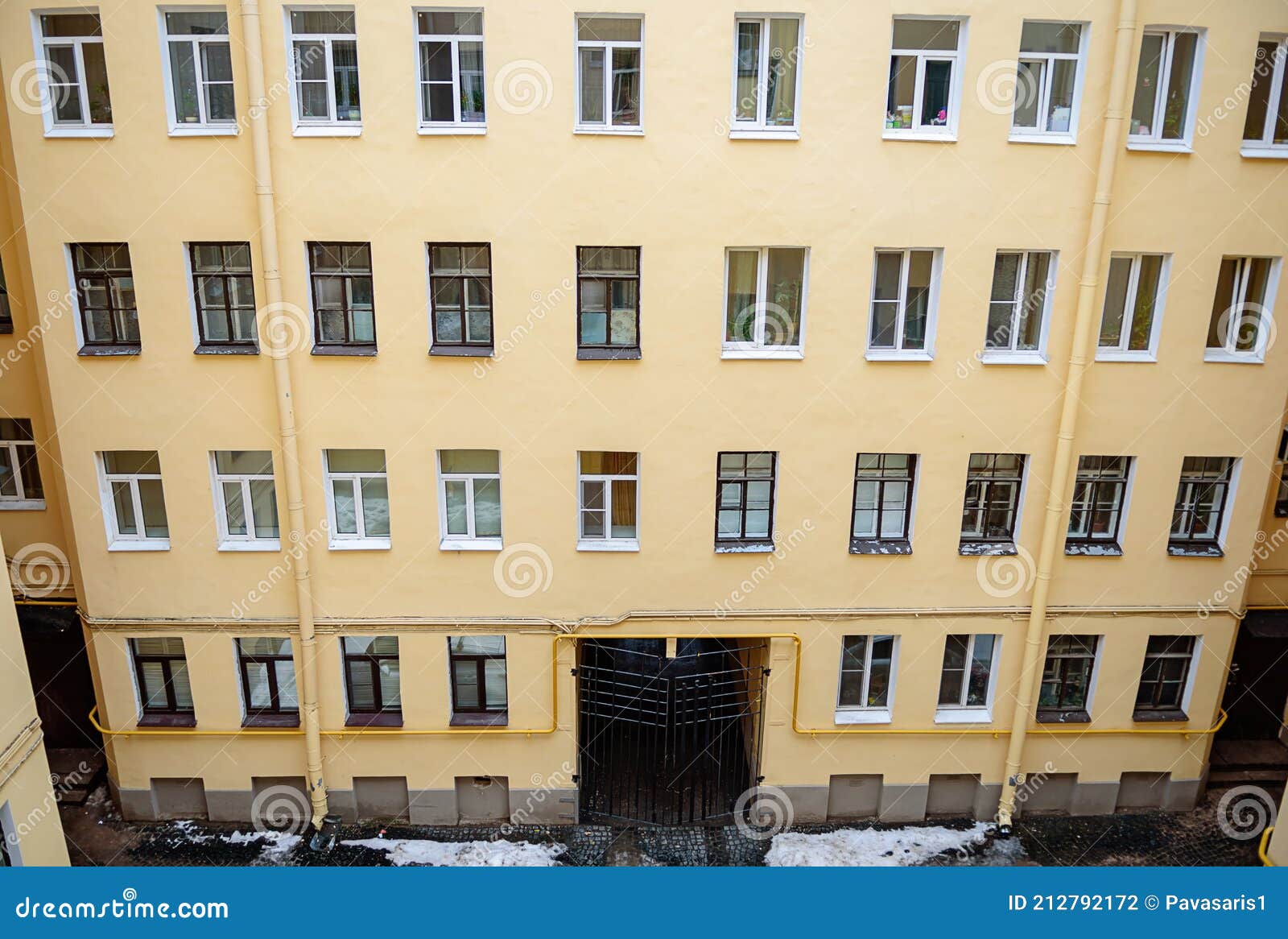 View of the Facade of a Yellow Apartment Building Stock Photo - Image ...