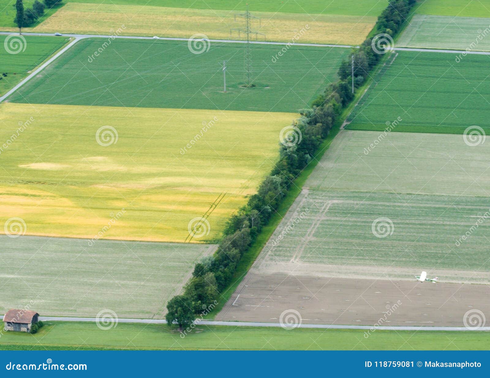Farming Fields and Rows of Trees with a Crop Duster Plane Seen from ...