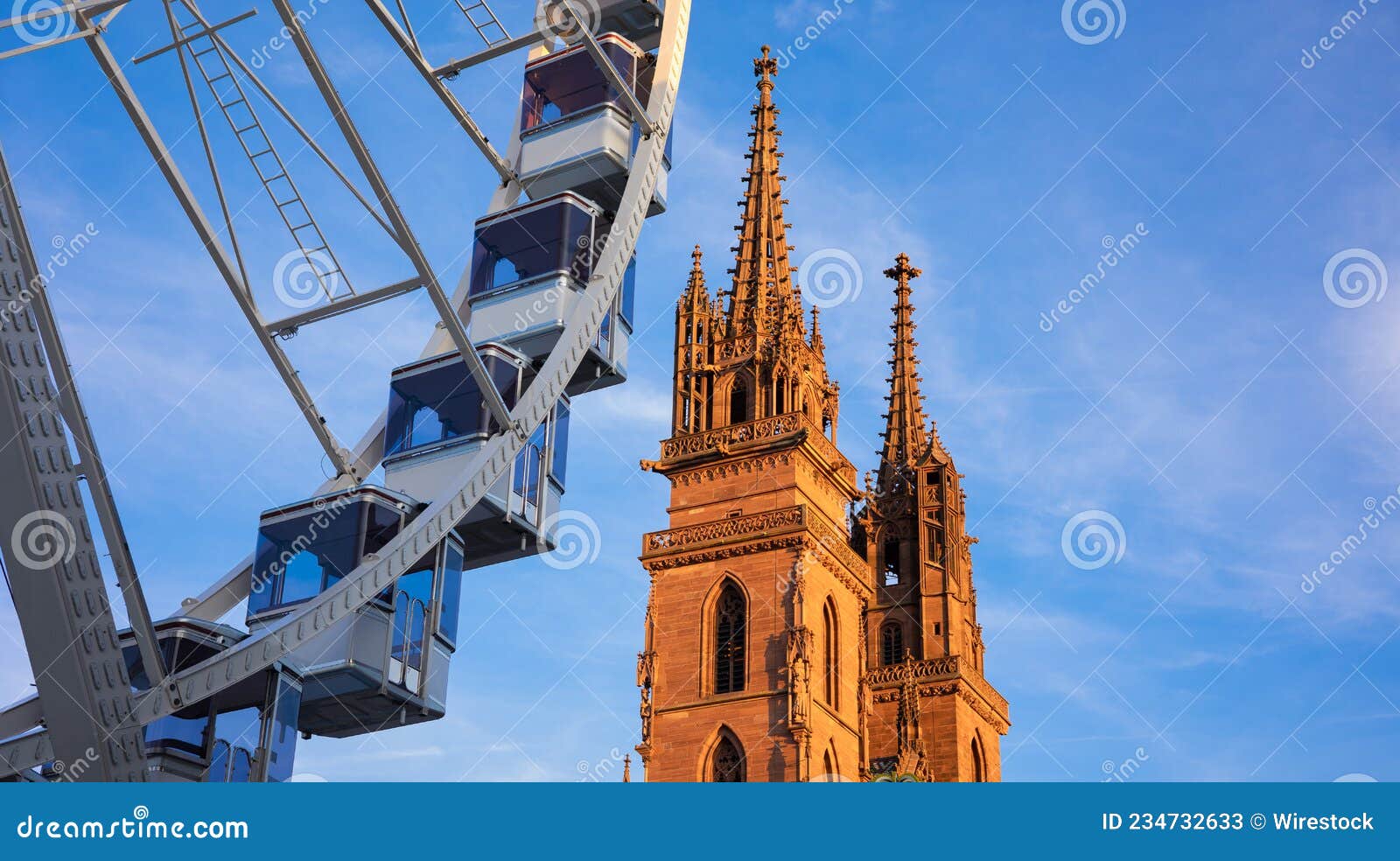View of a Ferris Wheel and Clock Tower of the Basel Minster during Fall ...