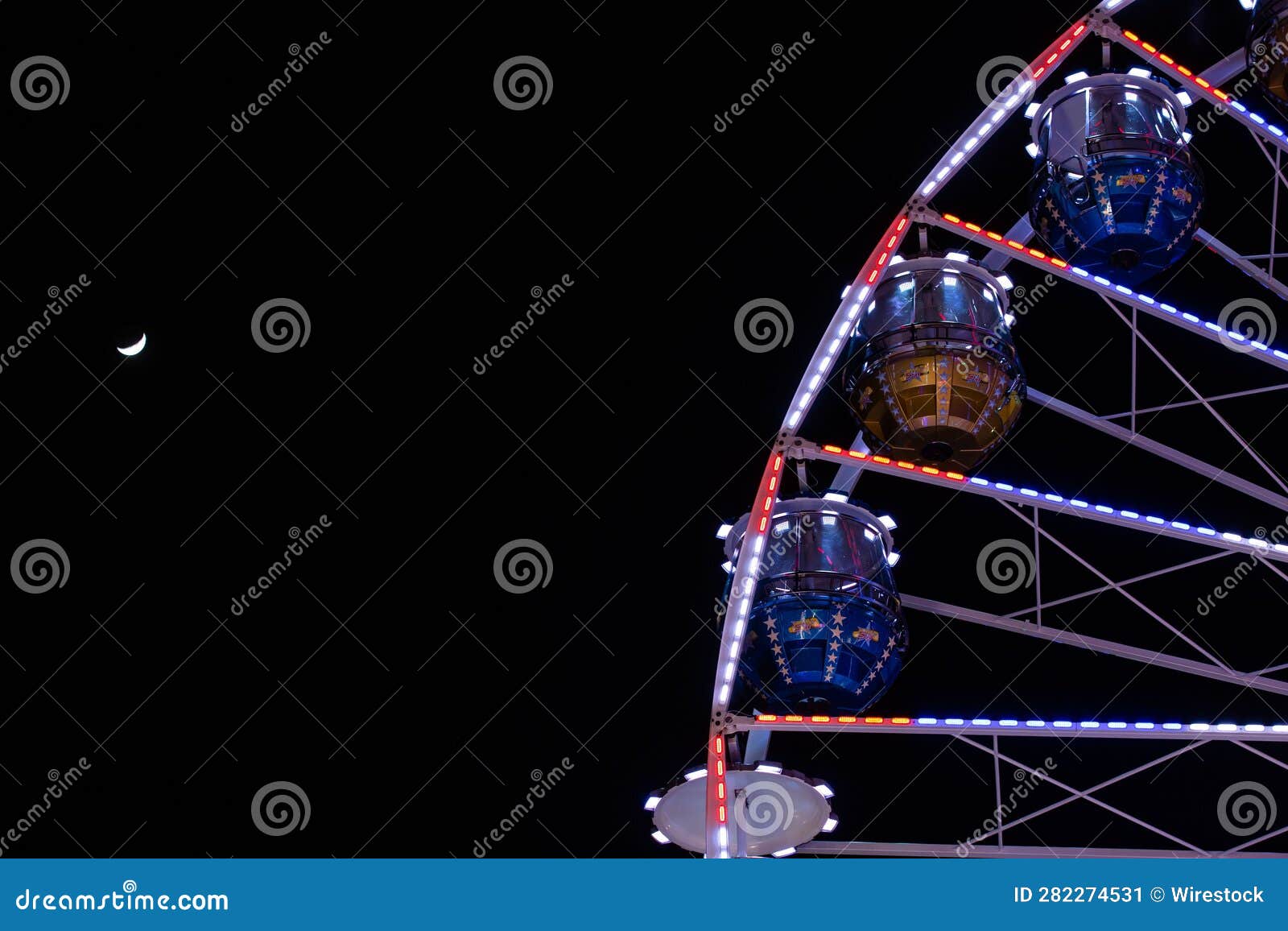 View of a Ferris Wheel Illuminated Against the Backdrop of a Night Sky ...