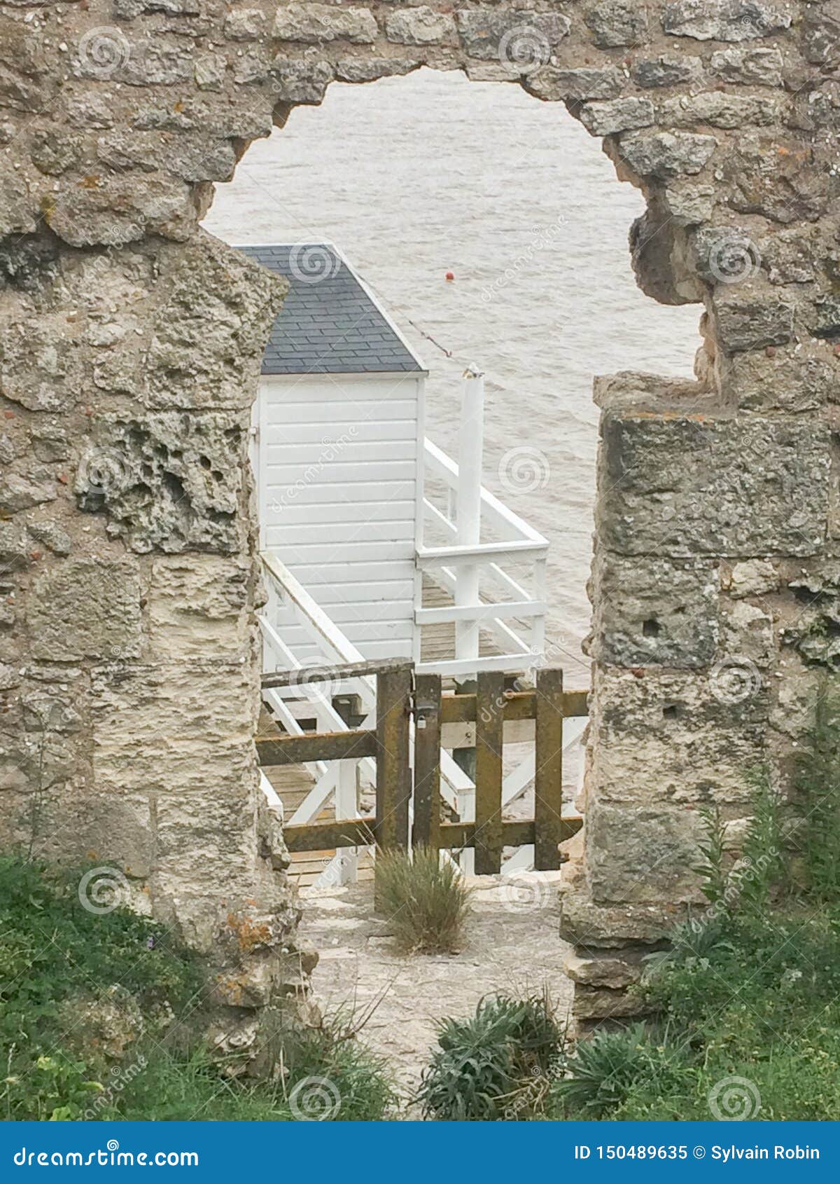View of Fishermen Huts through an Old Medieval Stone Gate Stock Image ...