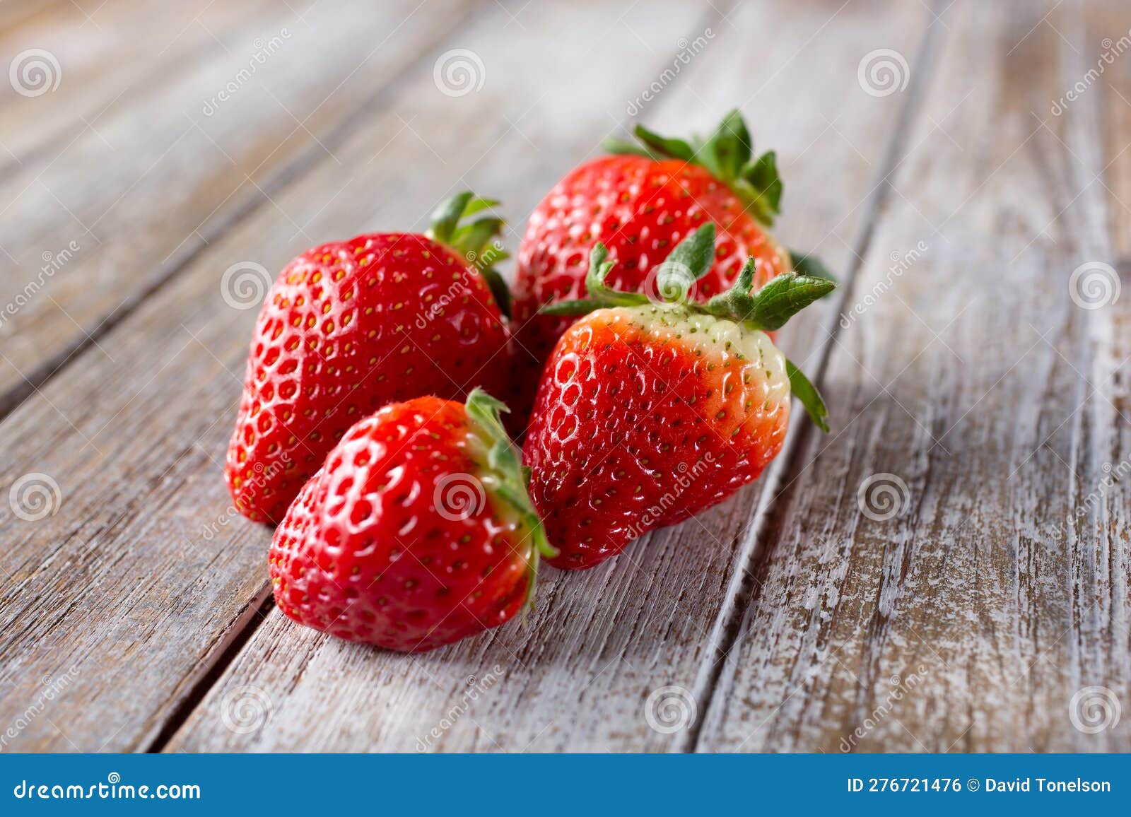Four Strawberries on Wood Table Surface Stock Photo - Image of crop ...