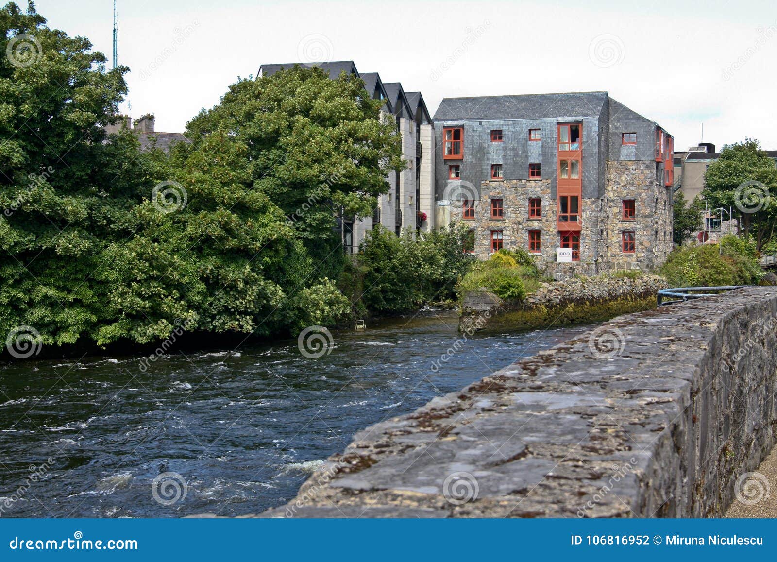 River Corrib Between A Pedestrian Walkway And Green Vegetation With The ...