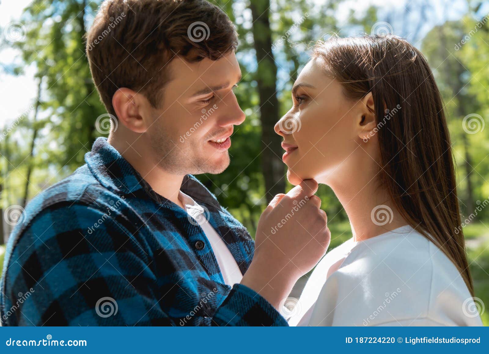 View of Happy Man Touching Face Stock Photo - Image of daytime, couple ...