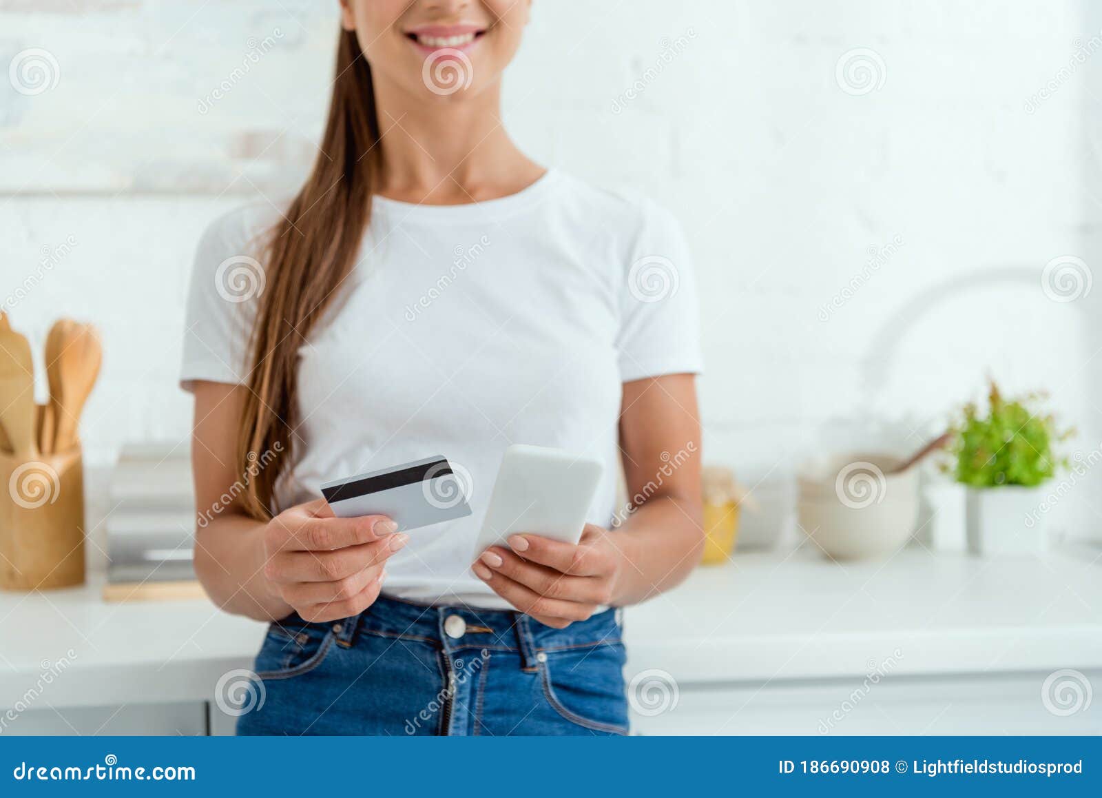 View of Happy Woman Holding Smartphone and Credit Card Stock Photo ... View of Happy Woman Holding Smartphone and Credit Card Stock Photo ...