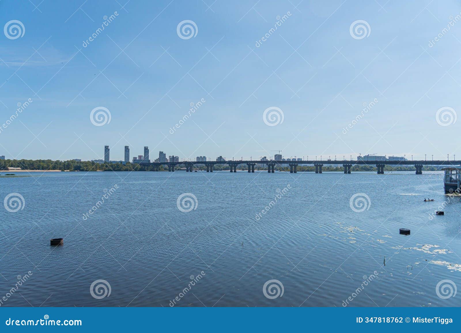 View of Harbor with a Small Structure, Bridge, Urban Skyline, and River ...