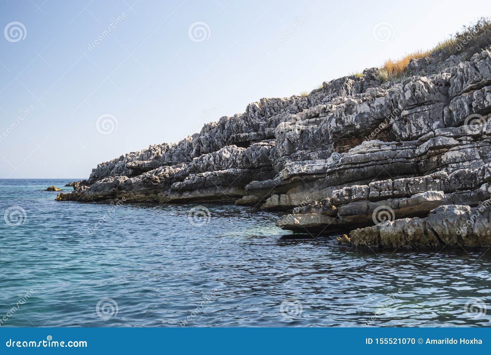 View of Himara rocky shore stock photo. Image of sarande - 155521070