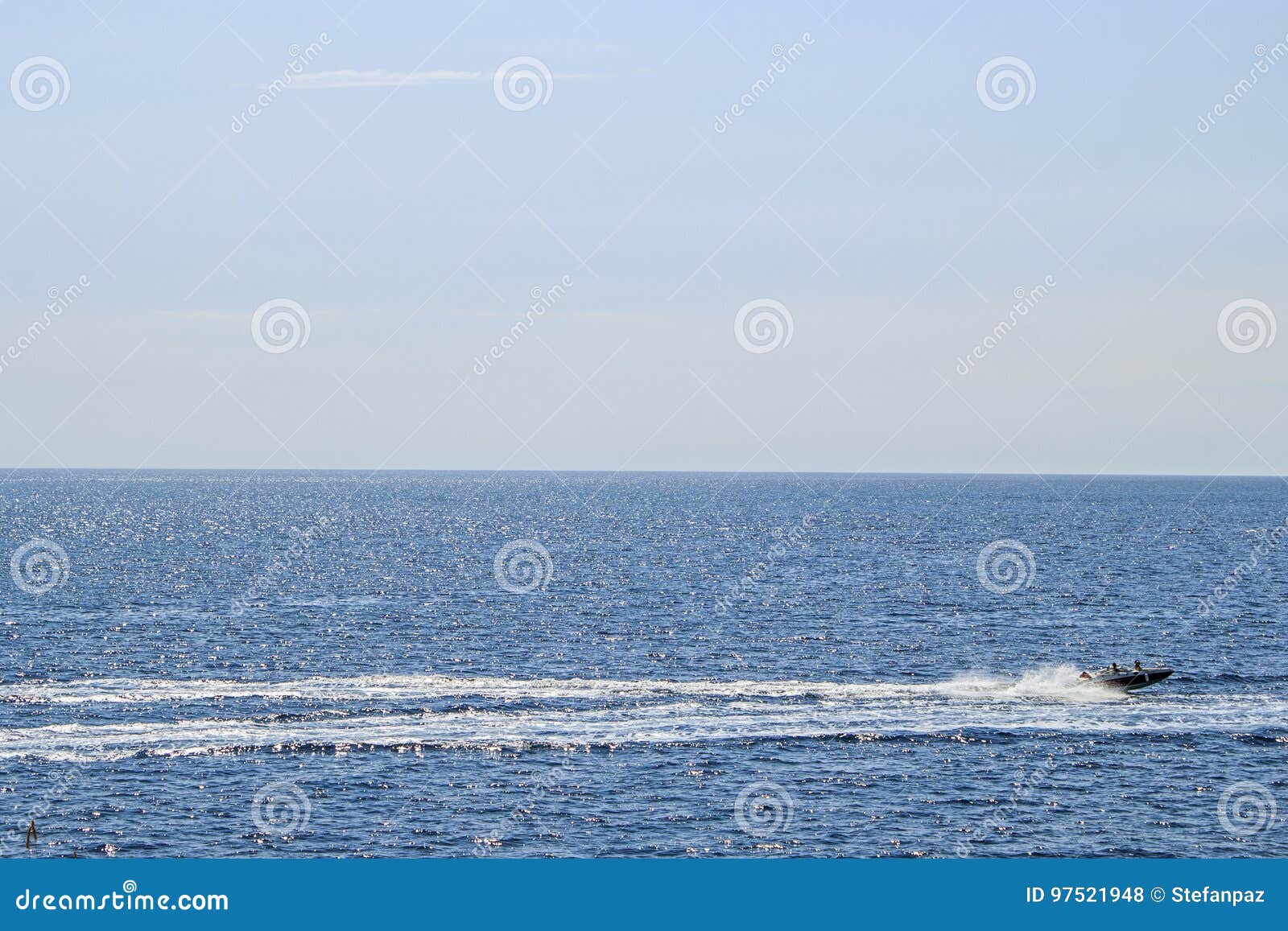 View on Horizon and Open Sea with Speed Boat Passing by Stock Photo ...