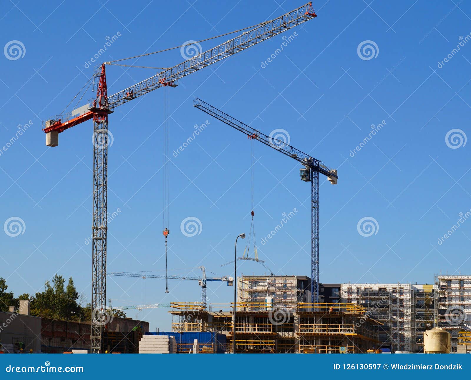 Three Cranes at Work. View of the House Construction Site. Stock Image ...