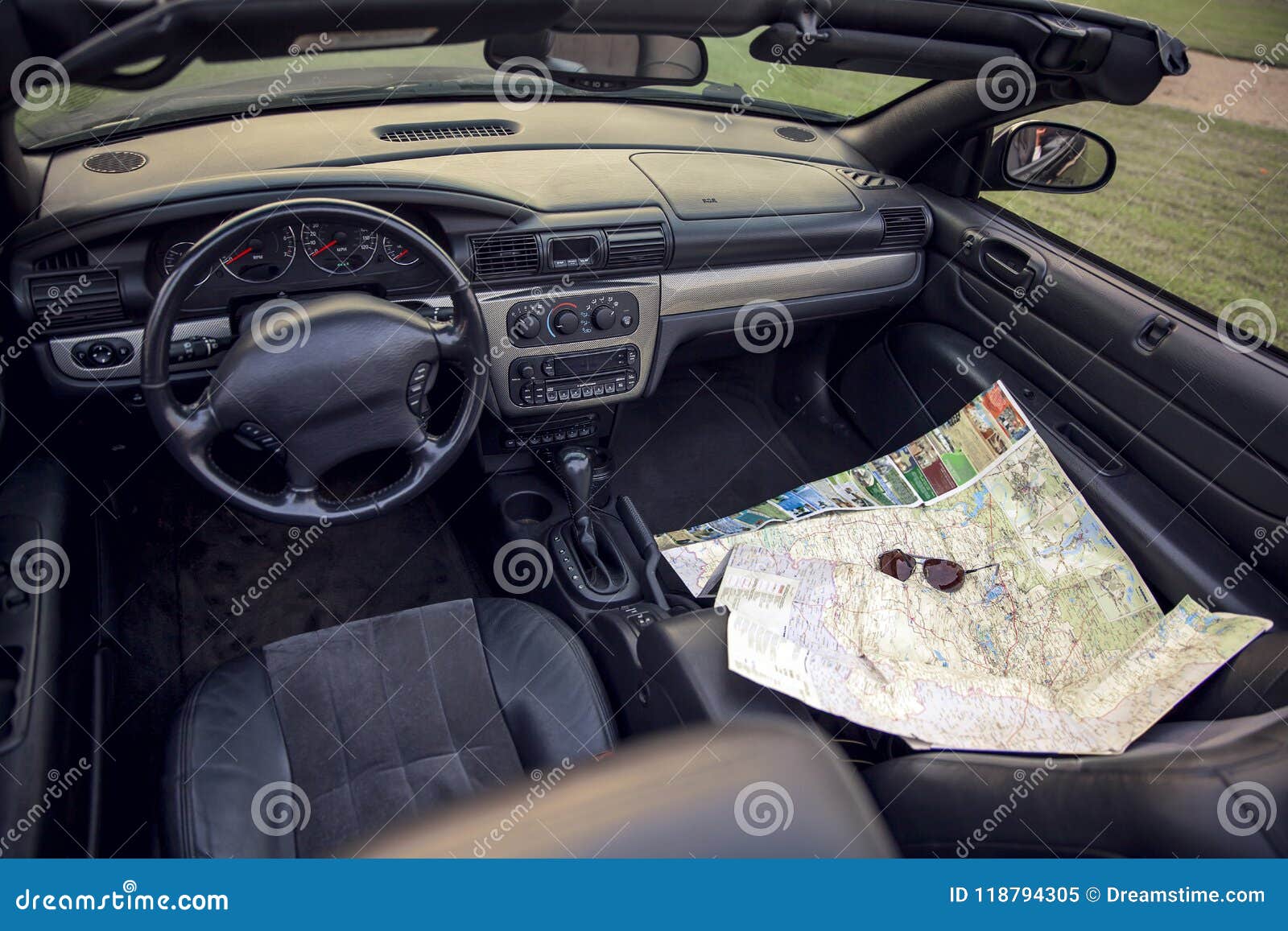 View from Inside a Car on a Dashboard with a Road Map and Glasses ...