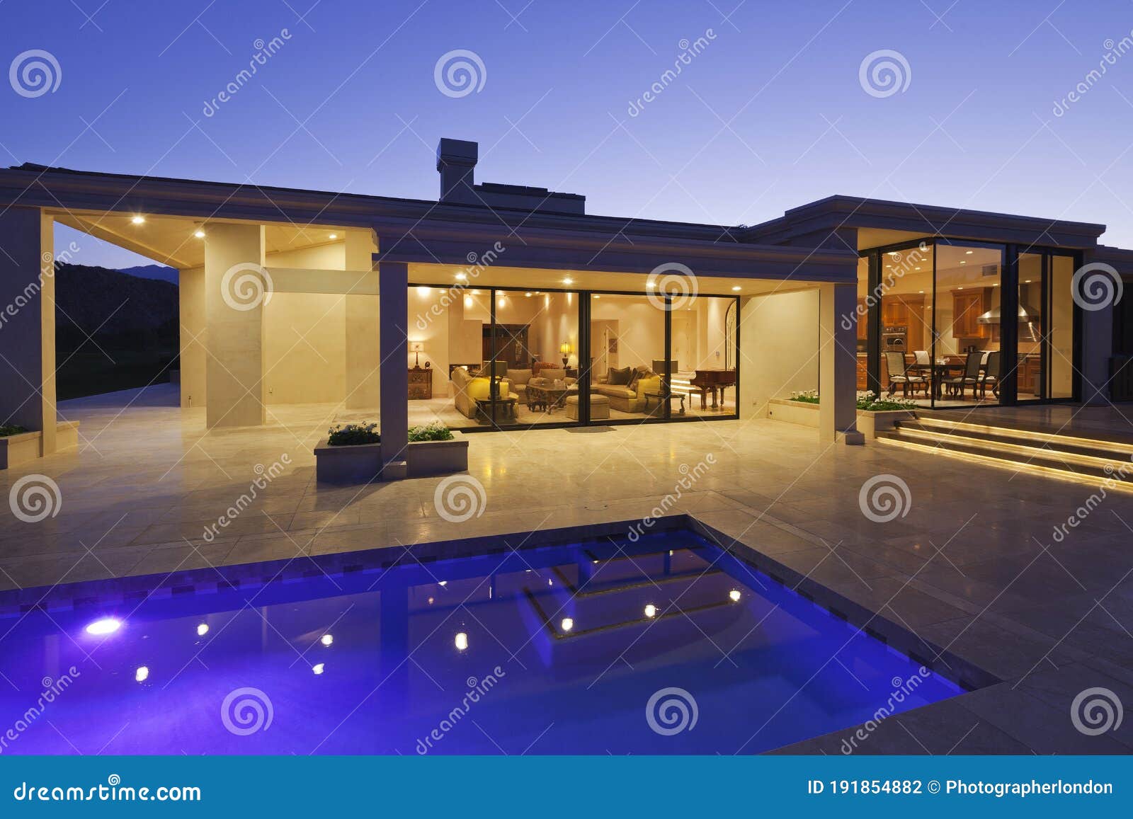 View Inside Modern Home with Swimming Pool at Dusk Stock Photo - Image ...
