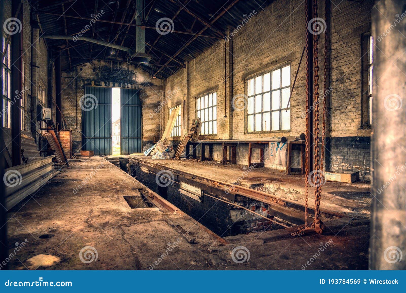 View Inside a Workshop with Rustic Chains, Brick Walls and Glass ...