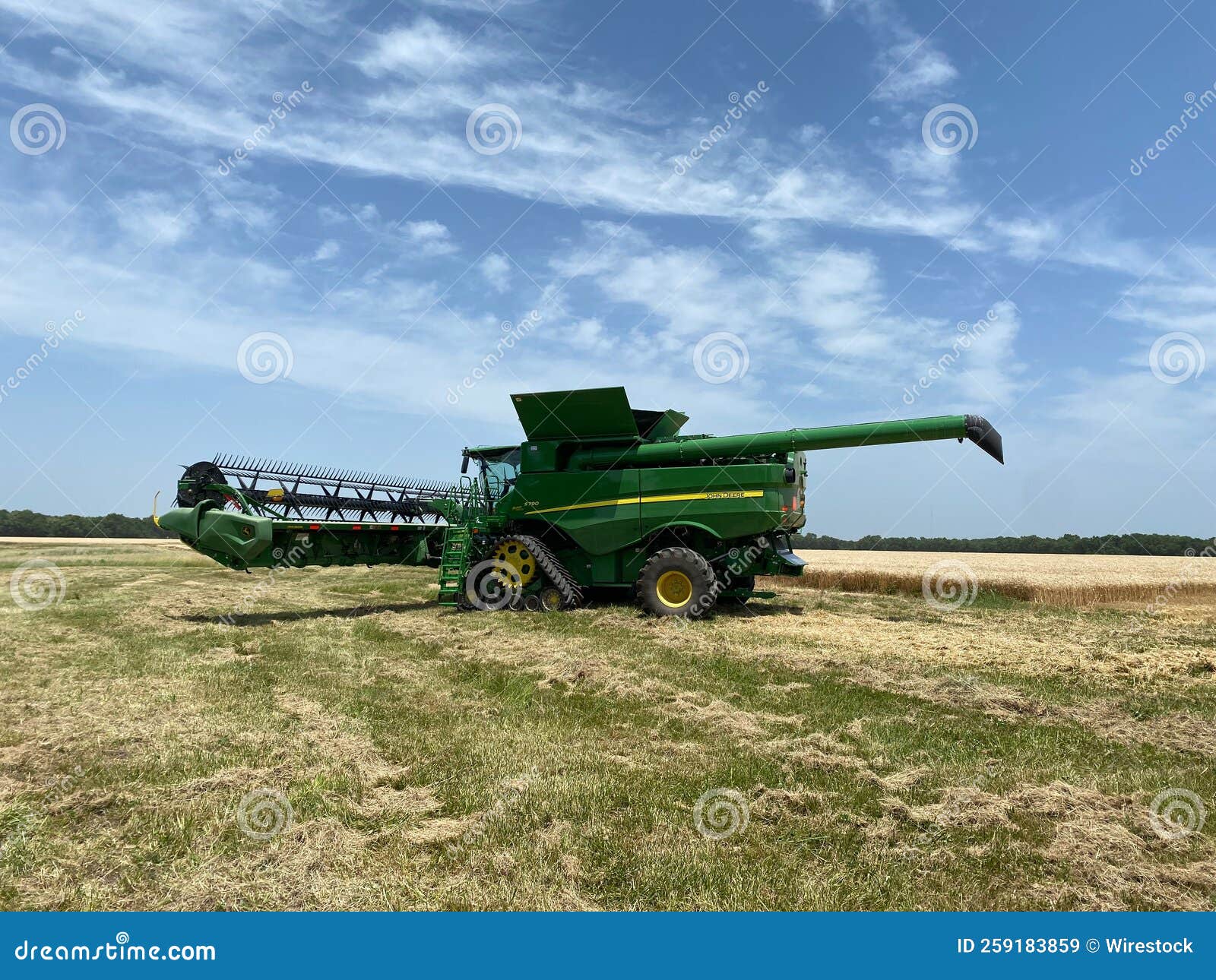 View of a John Deere Combine Harvester in the Field Under the Blue Sky ...