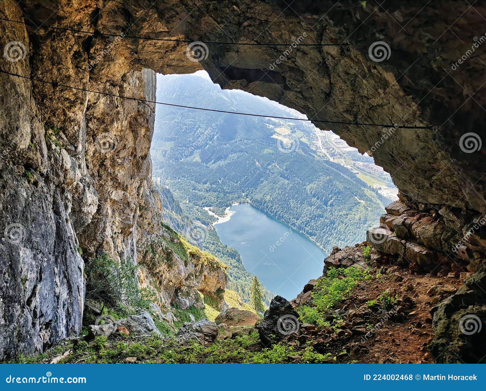 View of the Lake from the Cave High in the Rock Wall Stock Photo ...