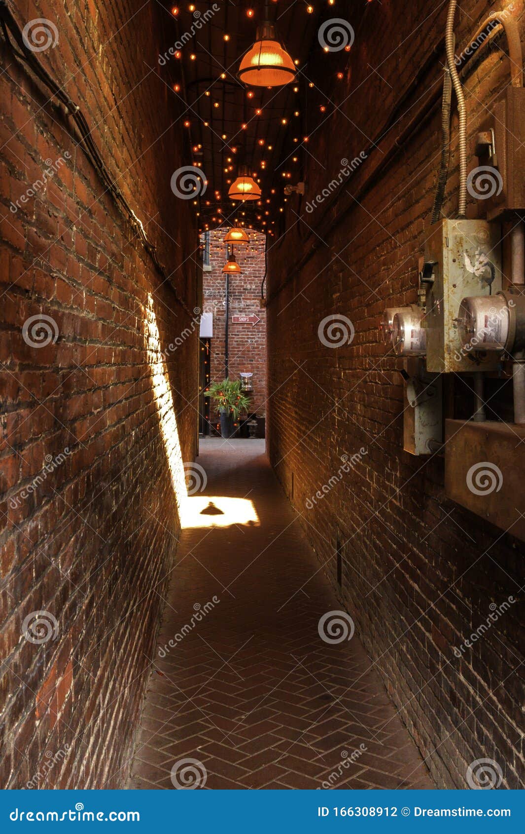 Looking Down a Softly Lit Alley with Warm Red Bricks Stock Photo ...
