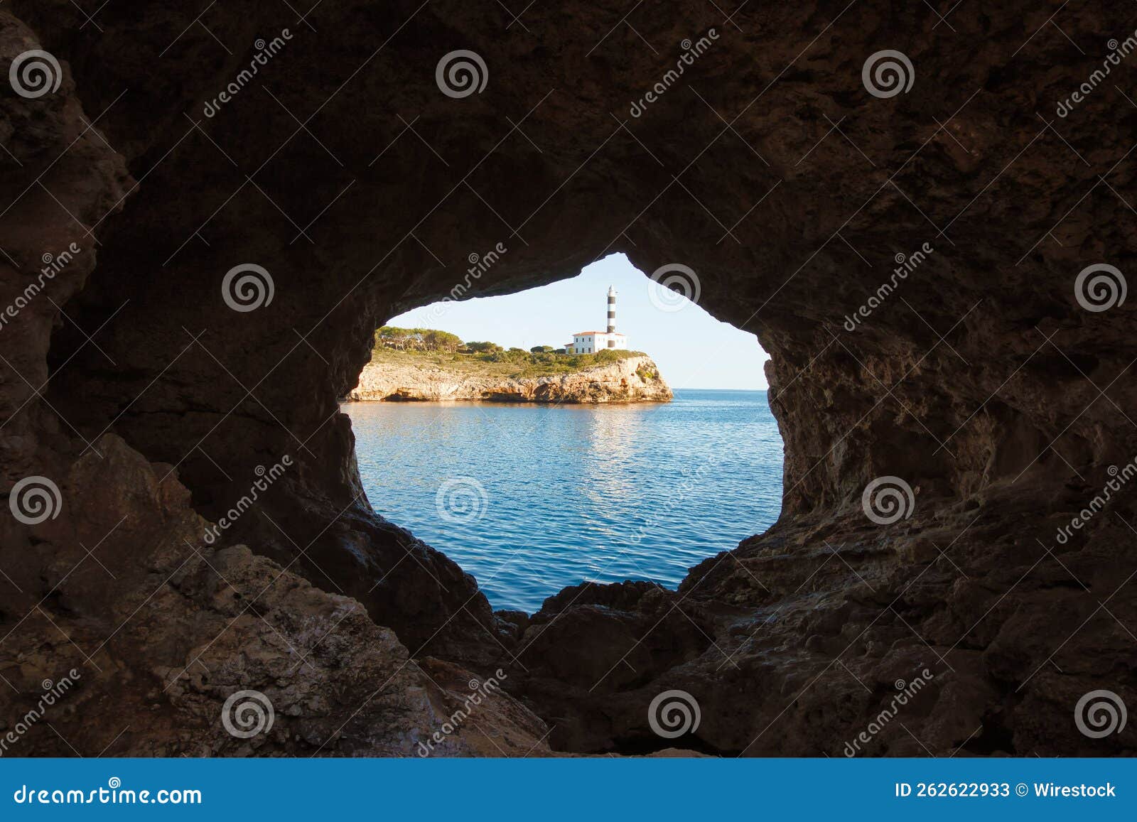 View of a Lighthouse at the Edge of a Cliff from the Waterside Cave ...