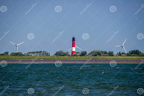 Lighthouse with Wind Turbines Stock Image - Image of beach, built ...