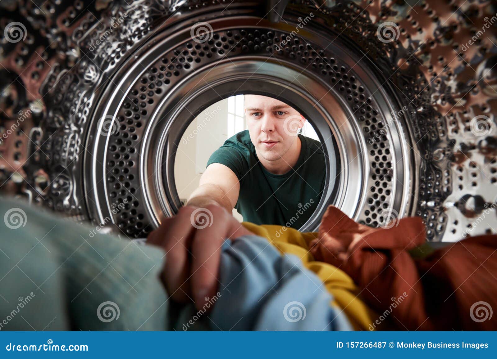 View Looking Out from Inside Washing Machine As Young Man Does Laundry ...